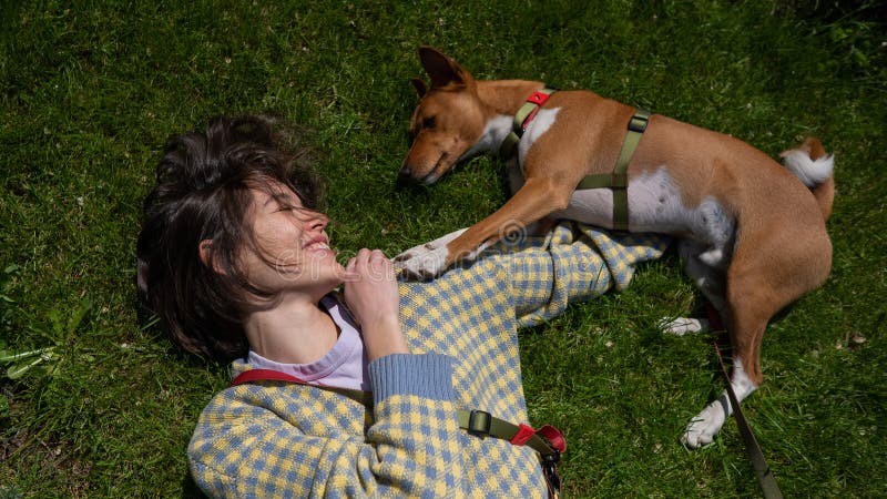 Top View of Beautiful Young Woman and African Basenji Dog Lying on ... Top View of Beautiful Young Woman and African Basenji Dog Lying on ...