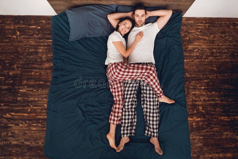 Top View. Beautiful Young Woman is Lying Next To Handsome Man. Sleep ... Top View. Beautiful Young Woman is Lying Next To Handsome Man. Sleep ...