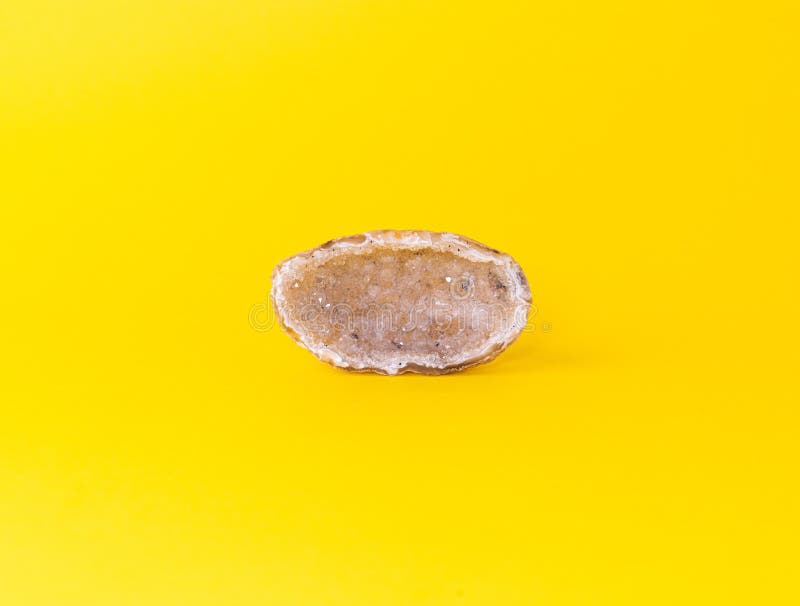 Top View of a Beige Crystal Druse Separated Over the Yellow Background ...