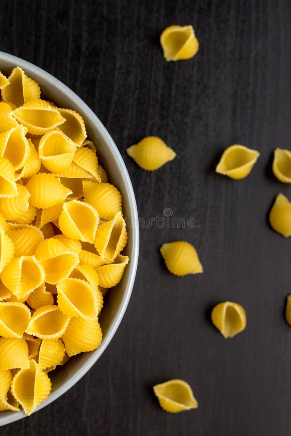 Top View of Black Background with Italian Raw Conchiglie Paste Shells ...