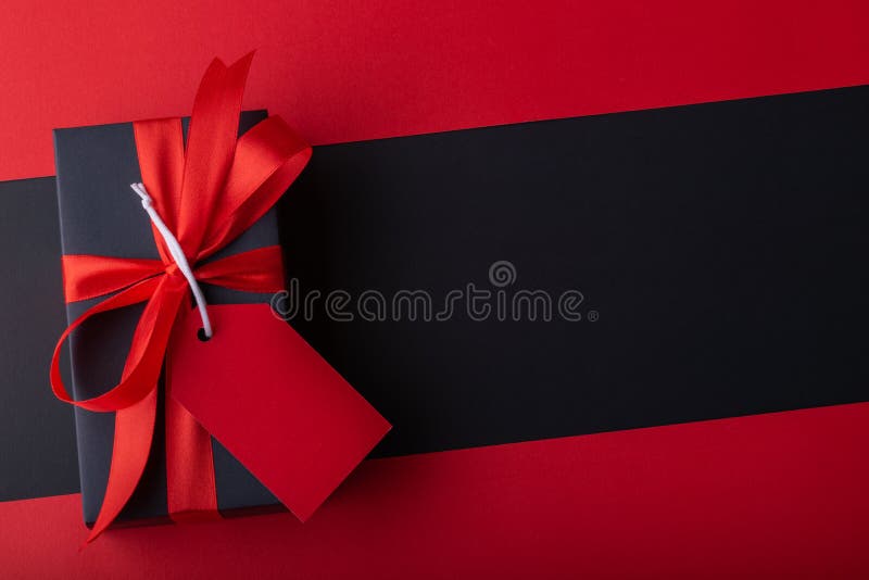Top View of Black Boxes with Red Ribbon on Black Background and Red ...