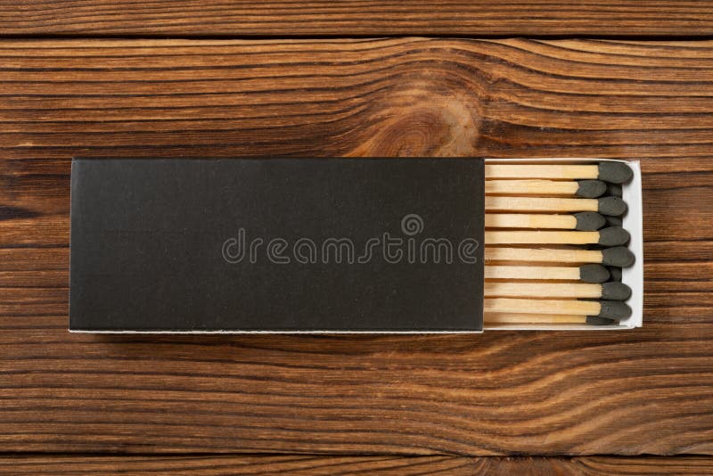 Black Color Matchbox with Black Match Sticks on a Wood Table Stock ...