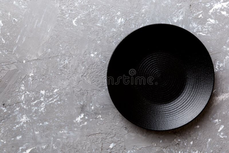 Top View of Black Plate on Cement Background. Empty Space for Your ...