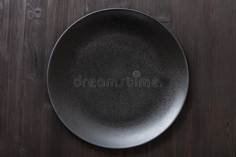 Top View of Black Plate on Dark Brown Table Stock Image - Image of ...