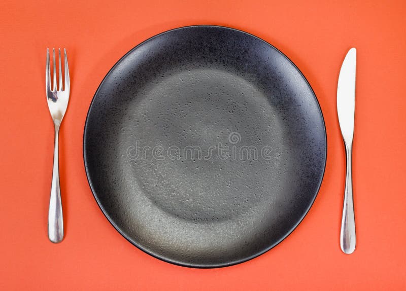 Top View of Black Plate, Fork, Knife Set on Red Stock Photo - Image of ...