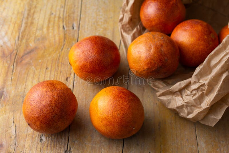 Top View of Blood Oranges in Paper Bag and Some on Rustic Wooden Table ...