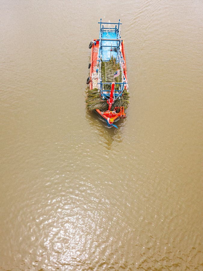 Top View of a Boat on a River Moving and Carrying Leaves. Stock Photo ...