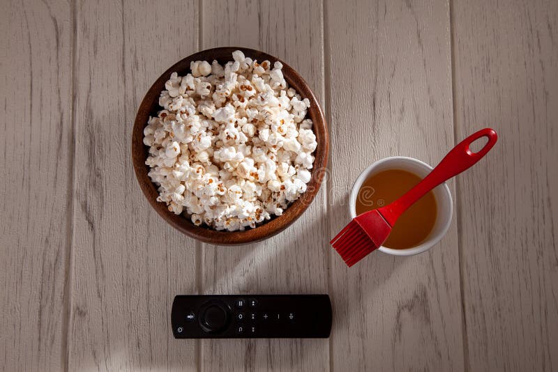 Top View of a Bowl of Popcorn, a Remote Controller, and a Bowl of ...
