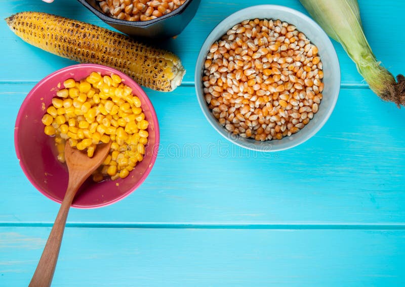 Top View of Bowls Full of Cooked and Dried Corn Seeds with Corn Cobs on ...