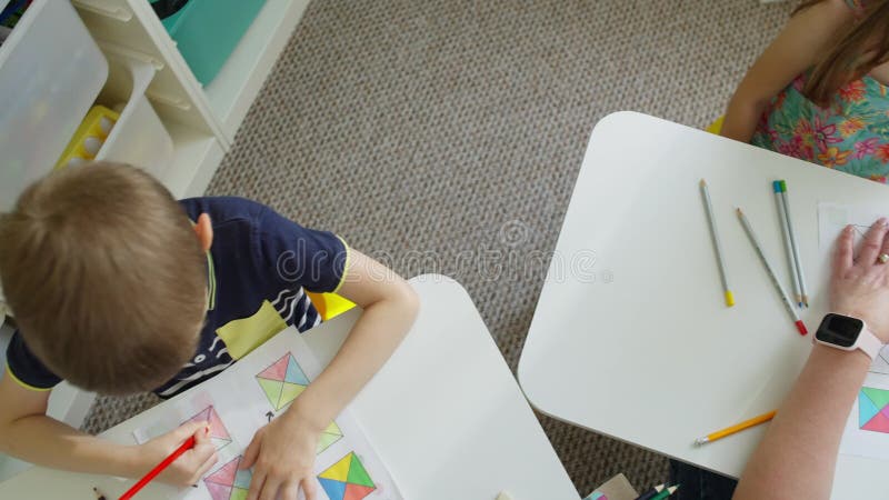 Top View of a Boy Doing a Logical Creative Task with Crayons. Stock ...