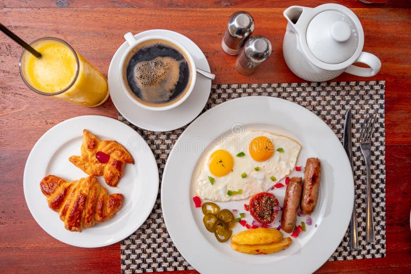 Top View of a Breakfast Spread with Fried Eggs, Pastries, Orange Juice ...