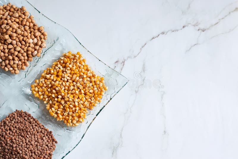 Top View of Brown Lentils, Corn Kernels, and Chickpeas in Four Separate ...