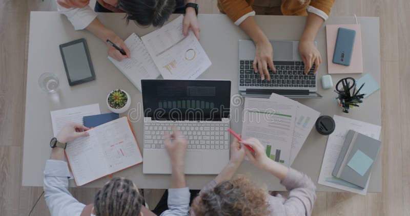 Top View of Business Team Working with Documents and Using Laptop ...