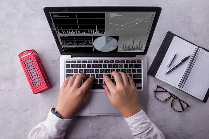 Top View of Businessman Using Laptop Computer with Statistics Data on a ...