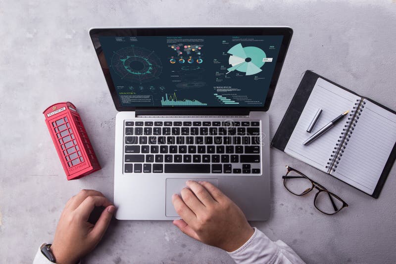 Top View of Businessman Using Laptop Computer with Statistics Data on a ...