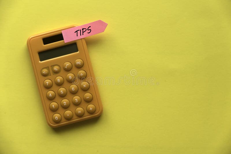 Top View of Calculator and Sticky Note Written with Tips on Yellow ...