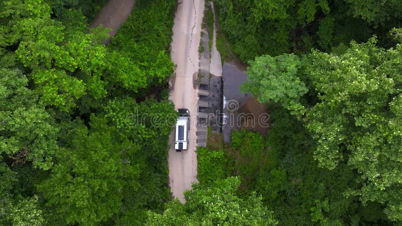 Top View of a Camper Van Navigating through a Lush Forest, Surrounded ...