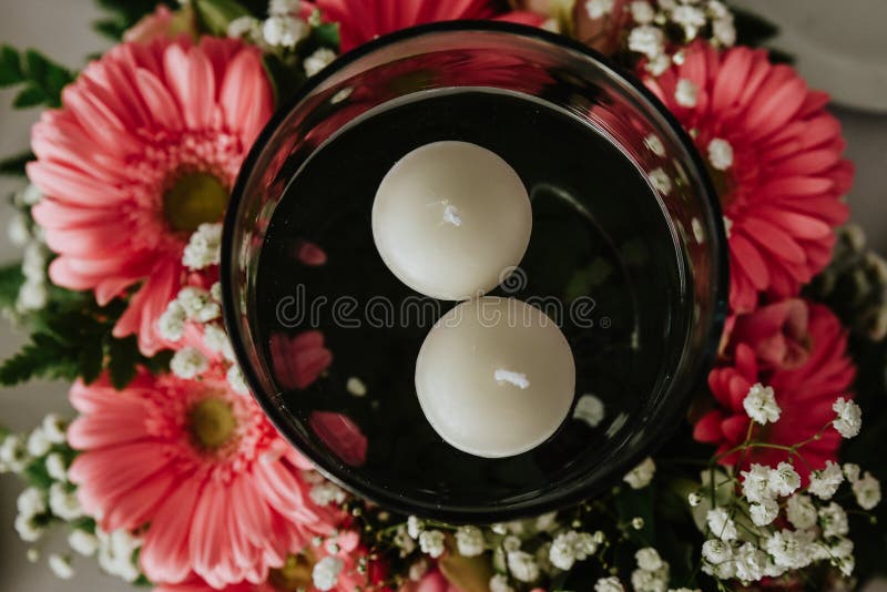 Top View of Candles Inside a Glass Container with Flowers Around it ...