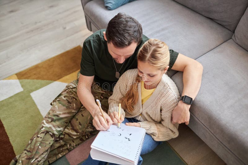 Top View of Caring Military Father Helping Daughter Doing Homework ...