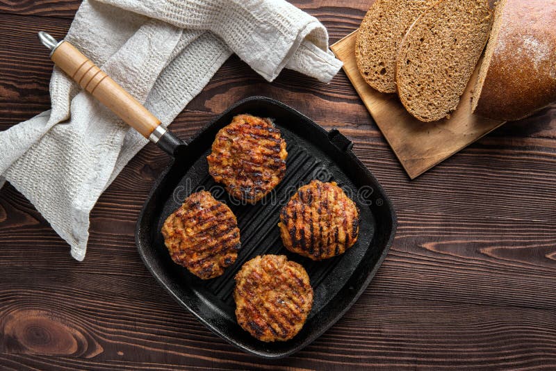 Top View of Cast Iron Pan with Beef Cutlets and Freshly Baked Brown ...