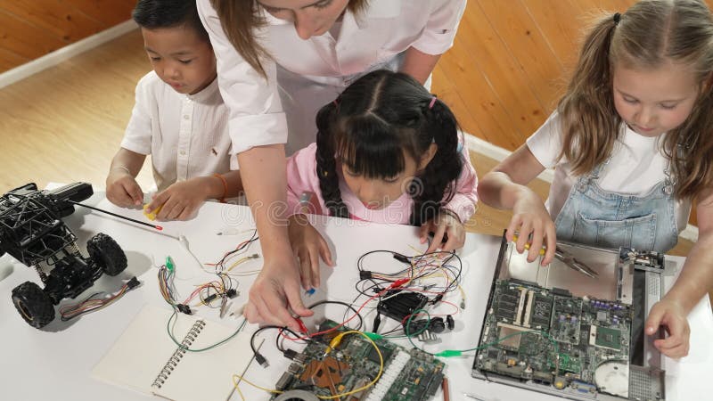 Young Smart Teacher Teaching Diverse Students about Electronic Board ...