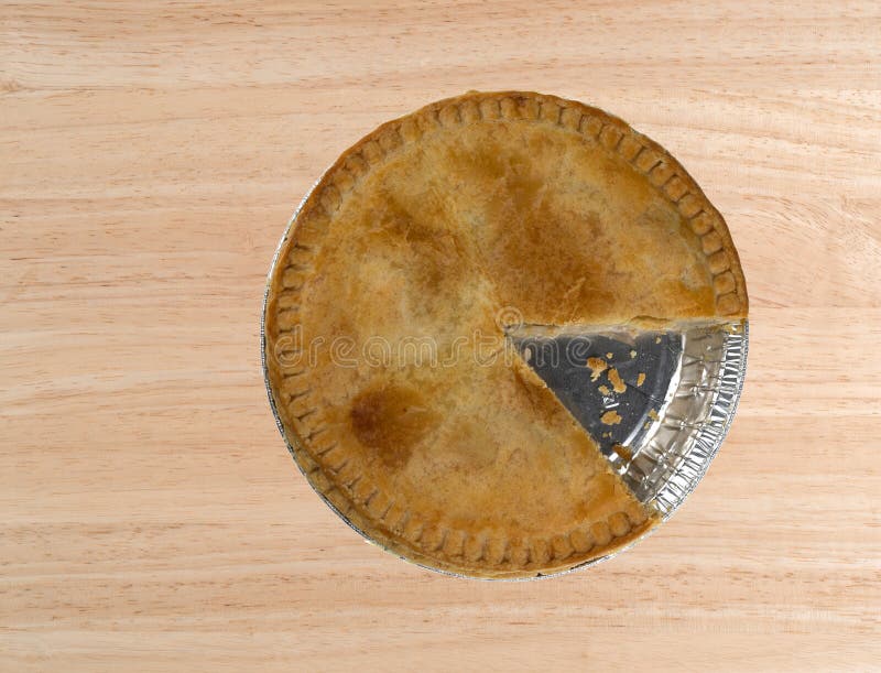 Top View of a Chicken Meat Pie with One Slice Missing on a Wood Table ...