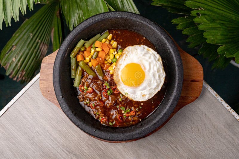Top View of a Chilli Dish with Fried Eggs and Vegetables As Side Dish ...