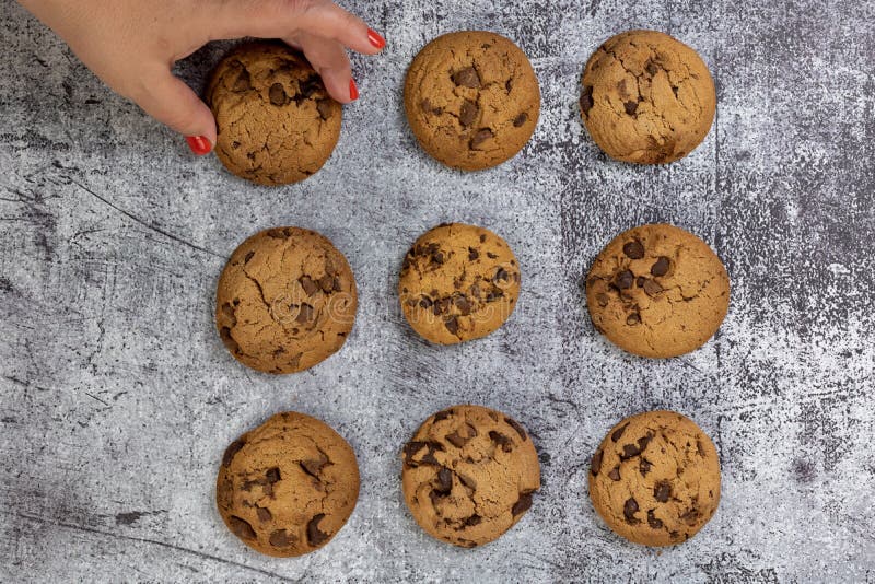 Top View of Chocolate Chip Cookies on a Textured Surface with a Woman ...