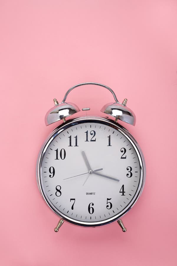 Top View of a Classic Analog Alarm Clock on Pink Background with Copy ...