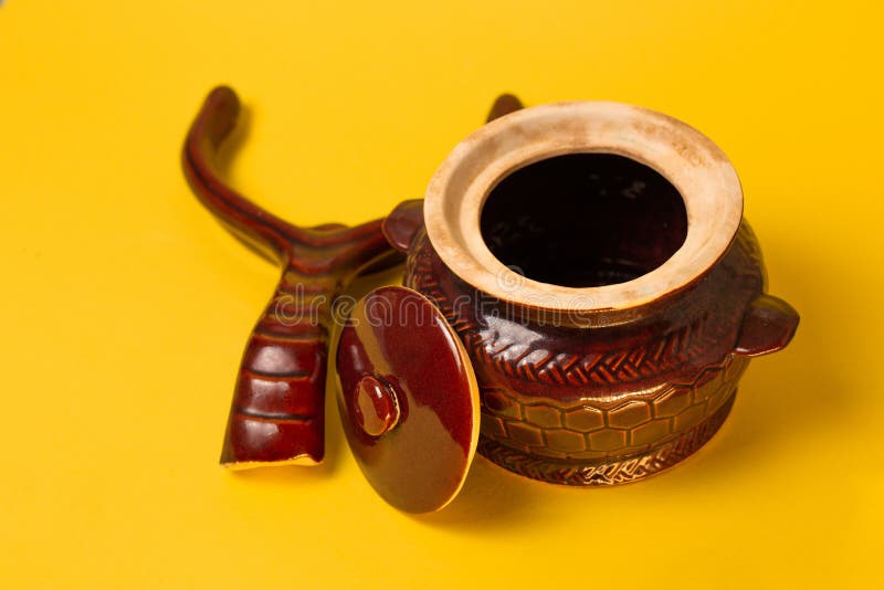 Top View. a Clay Pot and a Handle for Baking in the Oven on a Yellow ...