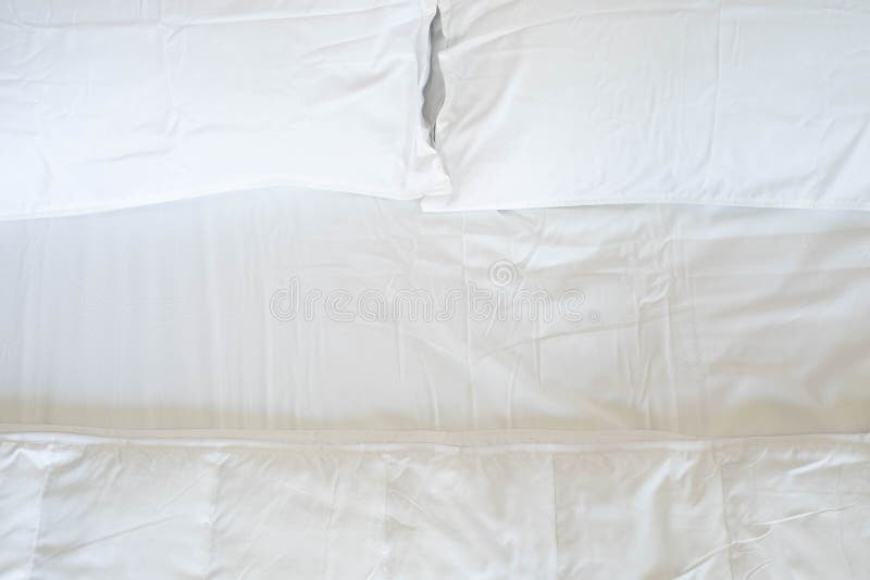Top View of Clean White Soft Pillows with Duvet and Bed Sheets on the ...