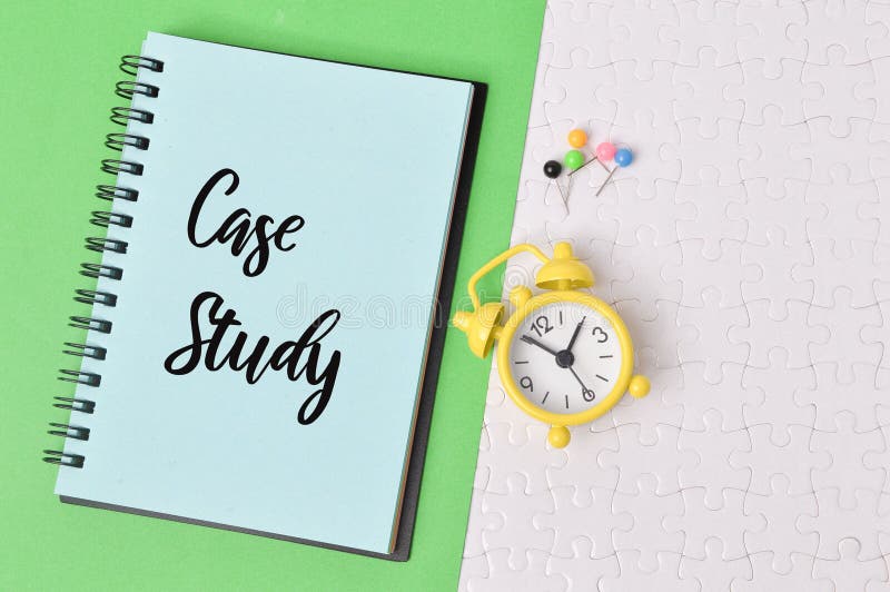 Top View of Clock and Notebook with "CASE STUDY" Text on a White Puzzle ...