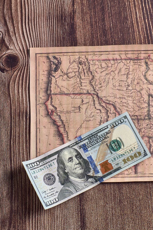 Top View Closeup of 100$ Banknote Placed on an Ancient Map on a Wooden ...