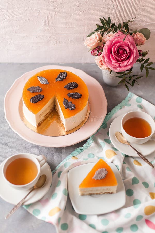 Top View Closeup of a Cake with Orange Icing on a Pink Surface on the ...