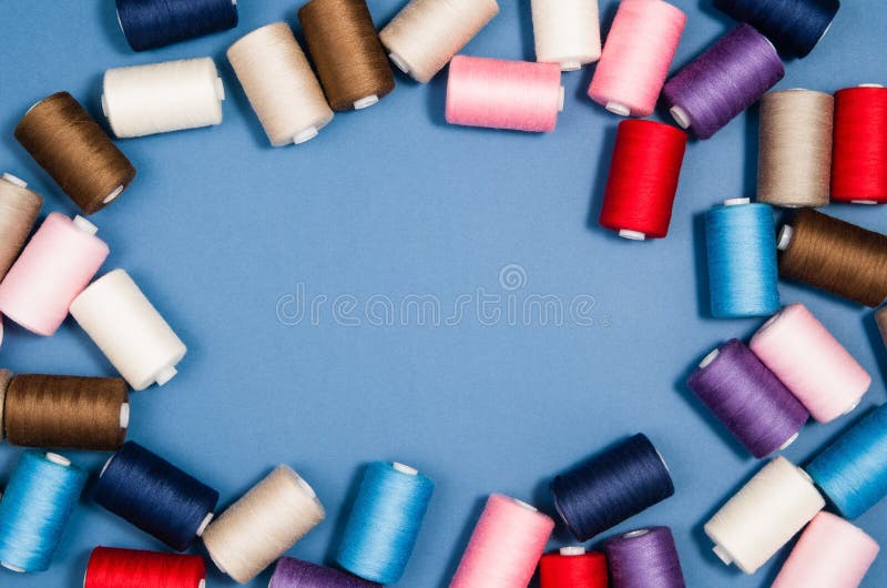 Top View of Colorful Thread Spools Over Blue Background Stock Photo ...