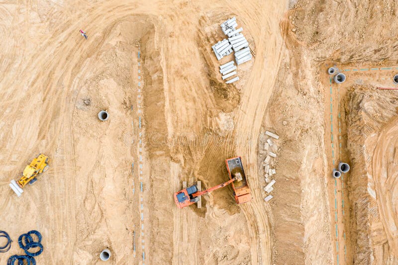 Top View of Construction Site. Excavators and Dump Trucks Loading Sand ...