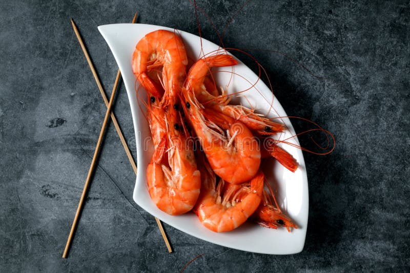 Top View of Cooked Shrimp on a White Platter with Sticks on a Gray ...