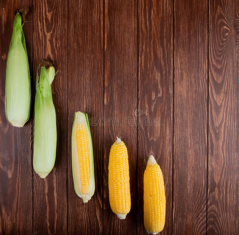 Top View of Cooked and Uncooked Corn Cobs on Left Side and Wooden ...