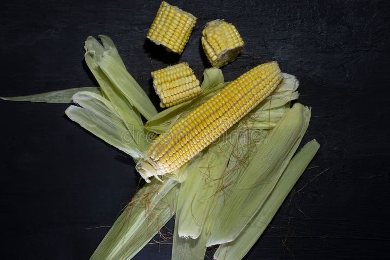 Top View of Corn in Its Leaves on a Dark Surface Stock Photo - Image of ...