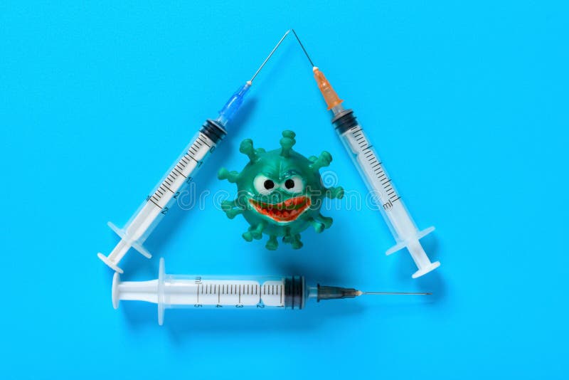 Coronavirus Surrounded by Triangle Shape Syringes on Blue Background ...