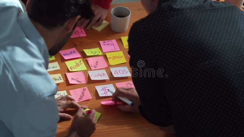 Top View of Creative People Writing Idea on Sticky Notes at Table ...