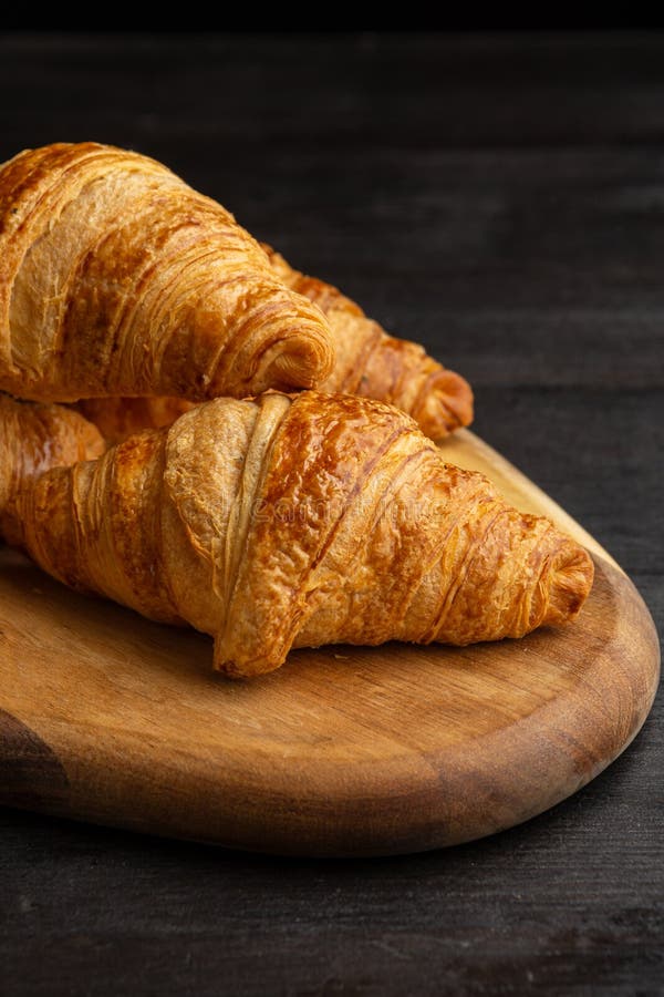 Top View of Croissants on Board on Dark Wooden Table, Vertical, Stock ...
