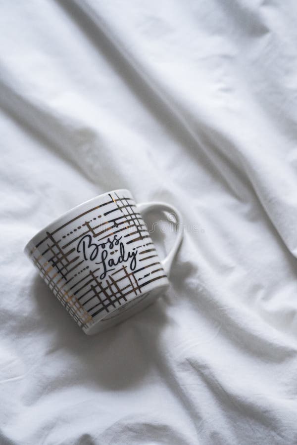 Top View of a Cup Labeled "Boss Lady" Resting on a Bed Stock Photo ...