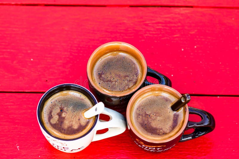 Top View of Cups of Freshly Made Coffee on a Red Wooden Surface Stock ...