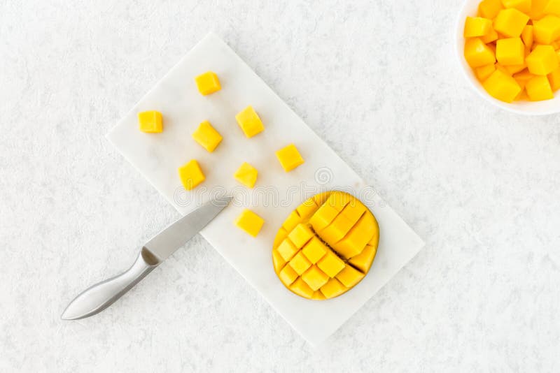 Cut Mango Half and Mango Cubes on Marble Cutting Board Stock Image ...