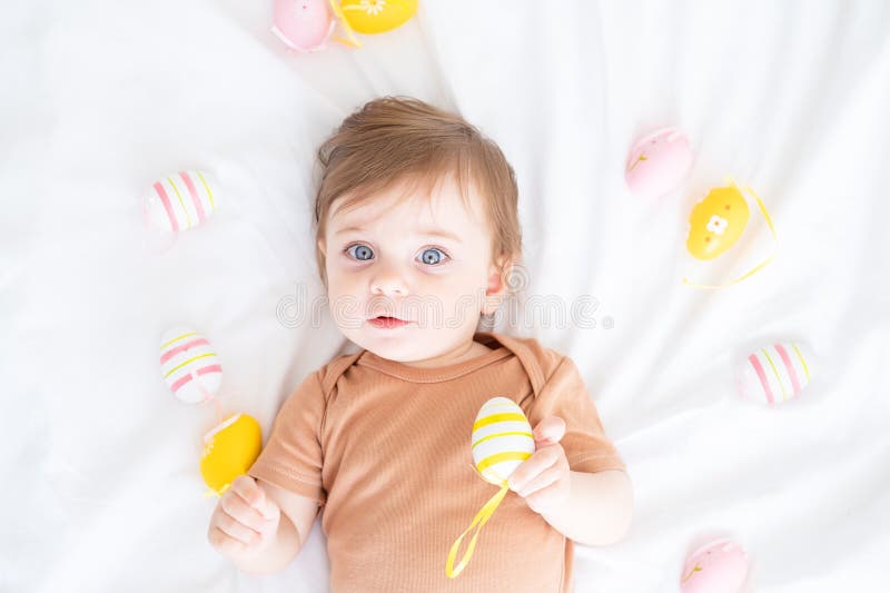 Top View of Cute Funny Baby with Colorful Easter Eggs on Bed at Home ...