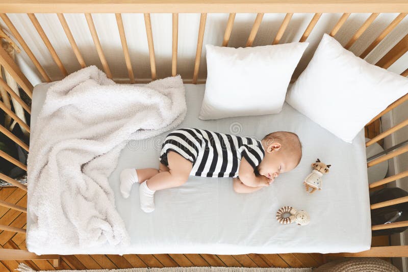 Cute Infant Baby Napping on His Side in Wooden Cot Stock Photo - Image ...