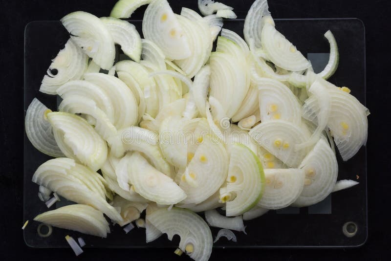 Top View of Cutted in Half Lengthwise Onion Strips on the Black ...