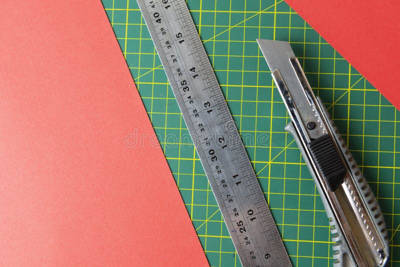 Top View of a Cutter and a Ruler on a Cutting Mat Under the Light Stock ...
