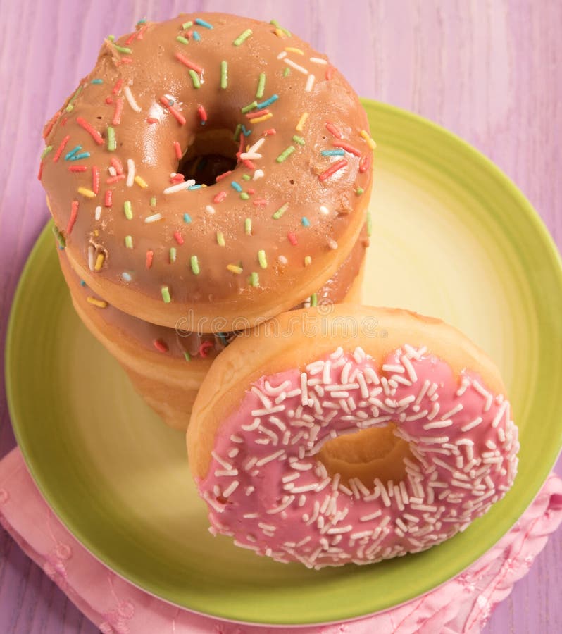 Top View of Delicious Donuts with Icing on Green Plate Stock Photo ...
